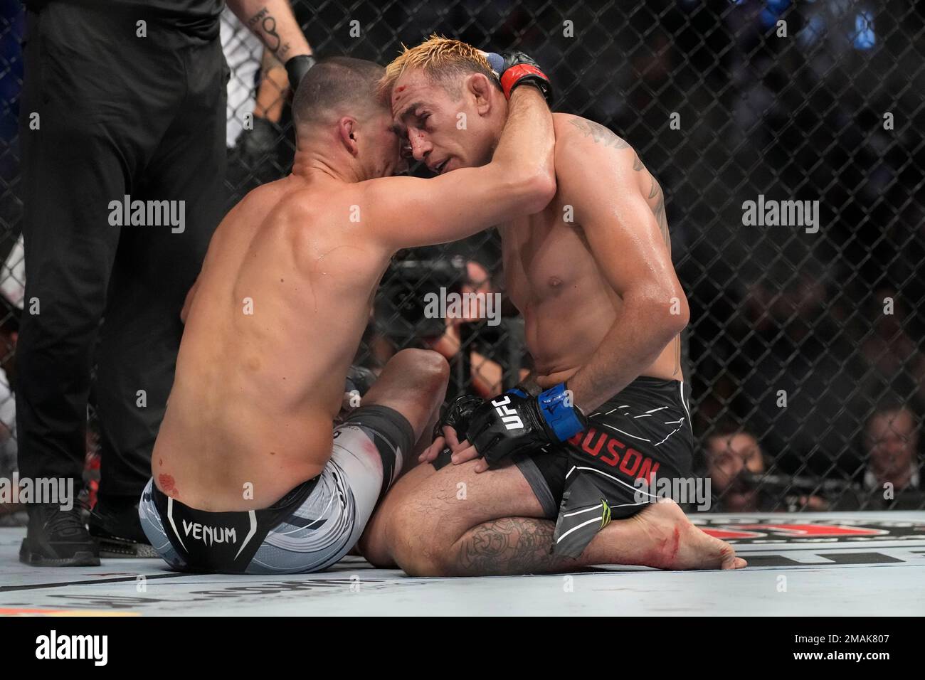 Nate Diaz, left, embraces Tony Ferguson after Diaz won their ...