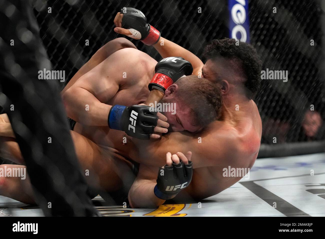 Ion Cutelaba, left, grapples with Johnny Walker in a light heavyweight ...