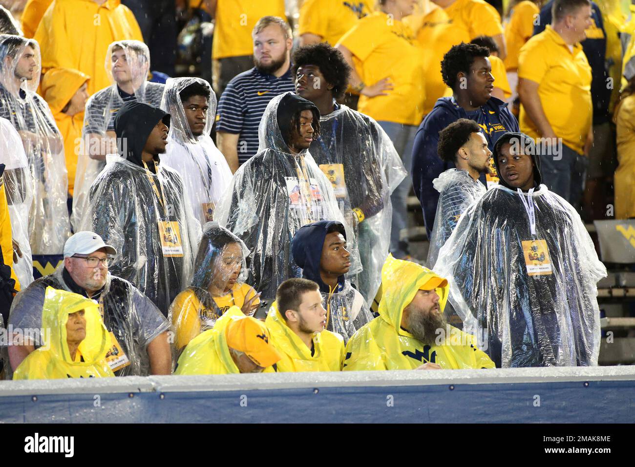 West Virginia fans endure rain during the second half of an NCAA ...