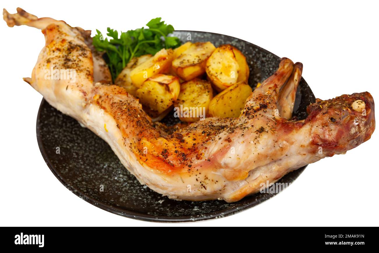 Whole baked young leveret with potatoes and greens Stock Photo - Alamy