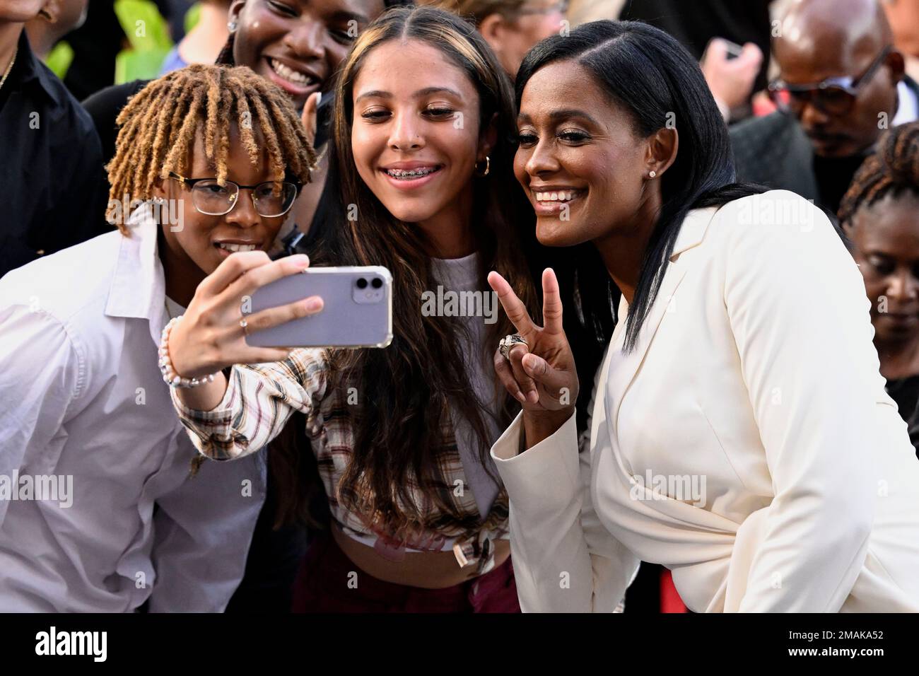 Swin Cash, right, poses for photos with fans as she arrives for the ...