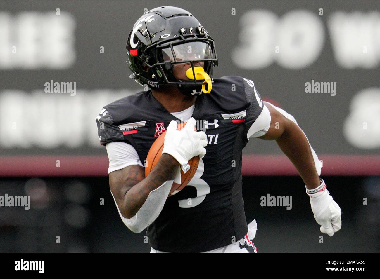 Cincinnati safety Ja'von Hicks runs for a touchdown after intercepting ...