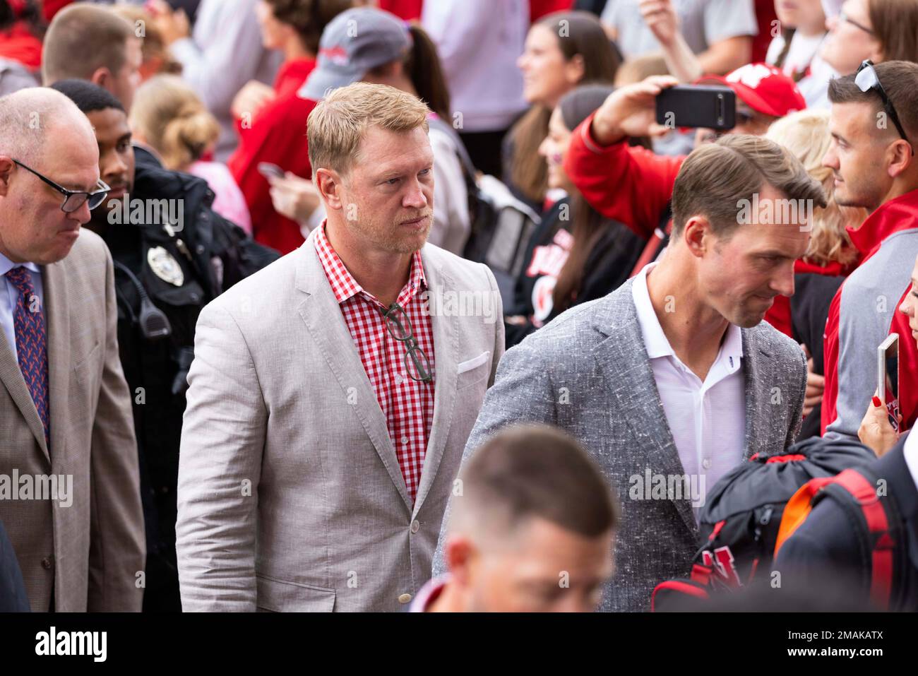 Nebraska head coach Scott Frost enters Memorial Stadium surrounded by ...