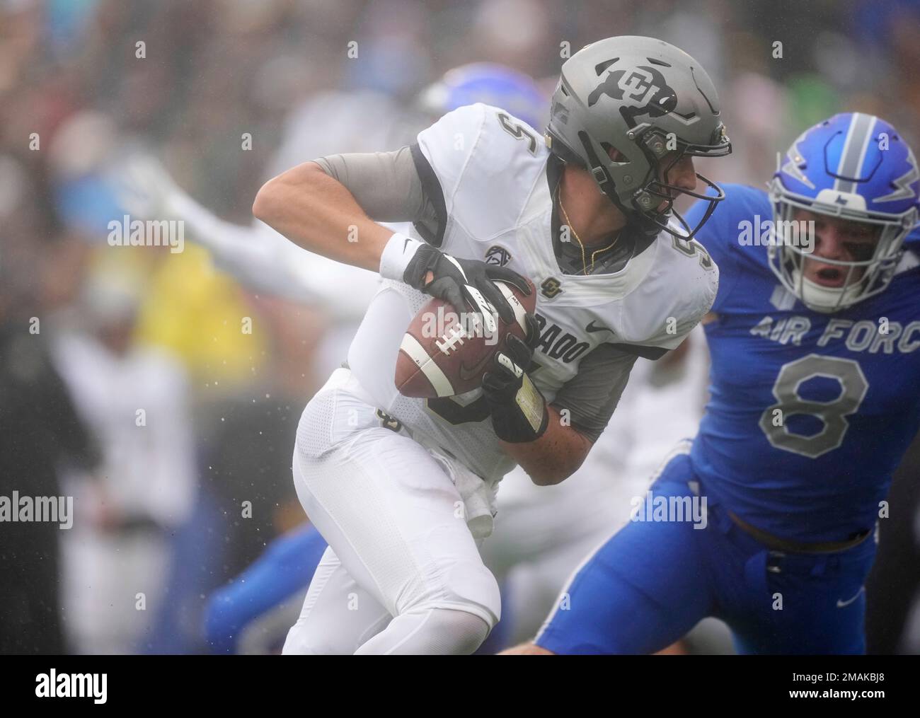 Colorado quarterback J.T. Shrout, front, is pursued by Air Force ...