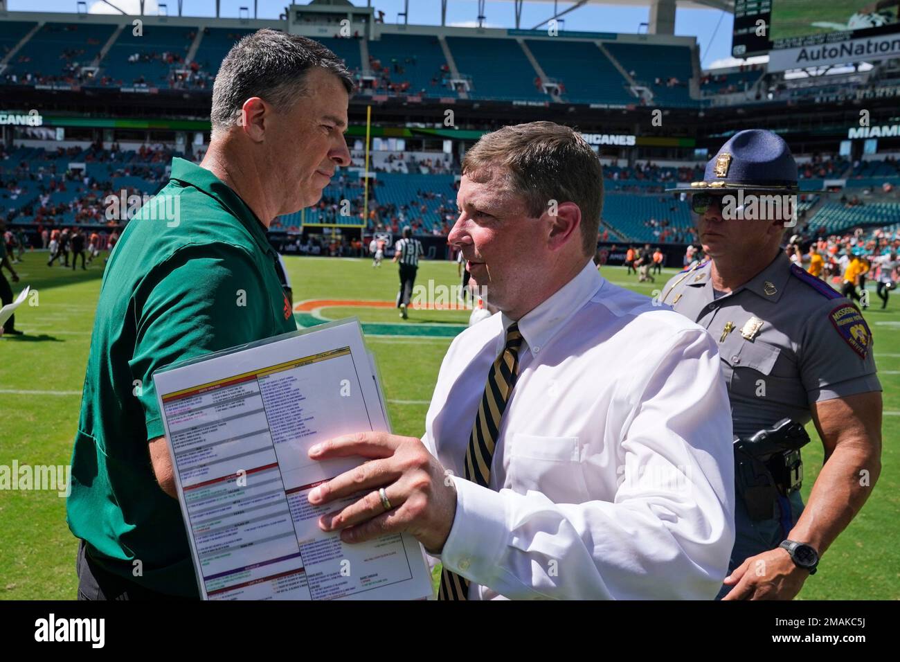 Miami head coach Mario Cristobal, left, and Southern Miss head coach ...