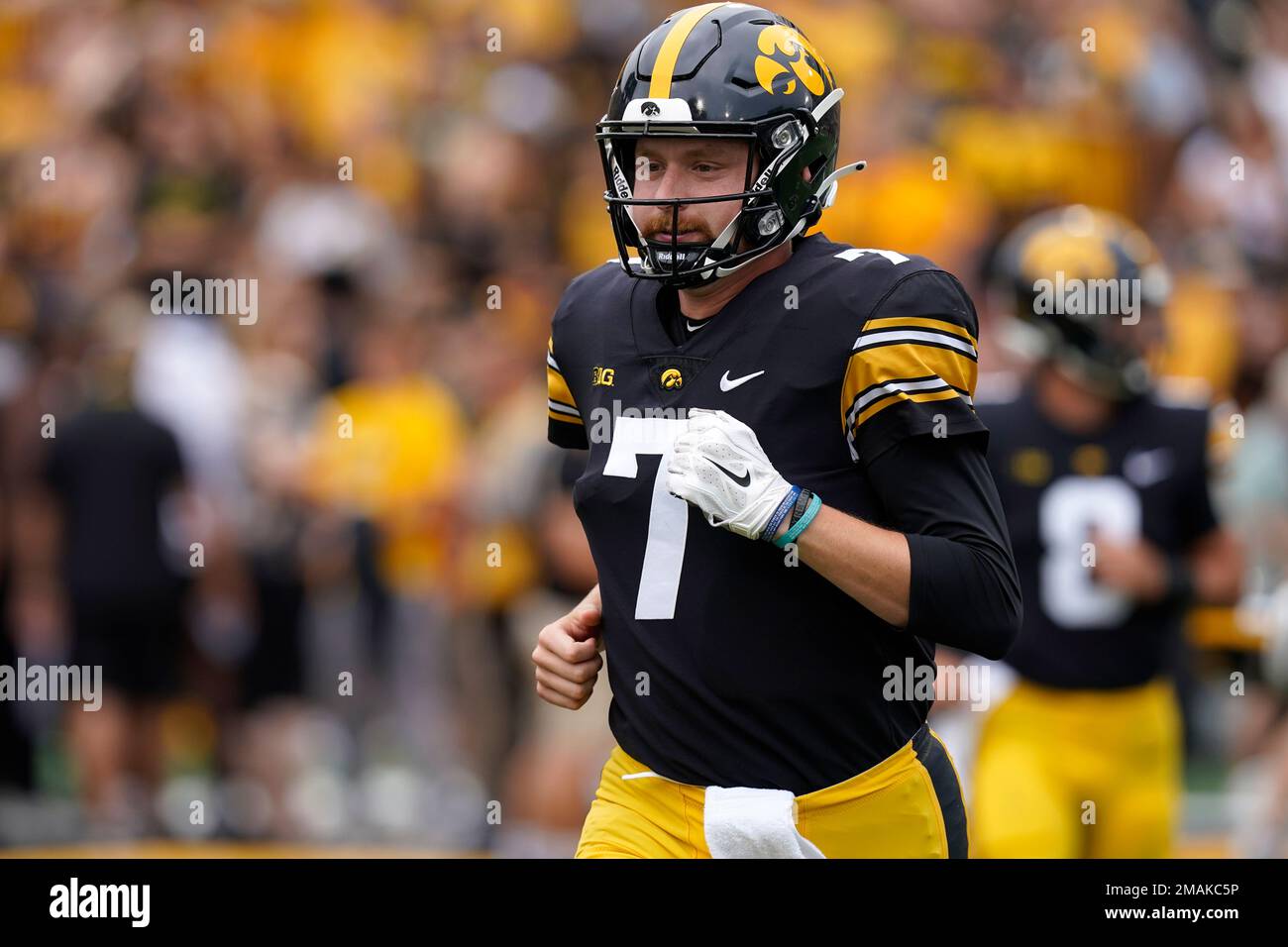 Iowa quarterback Spencer Petras (7) runs on the field before an NCAA ...