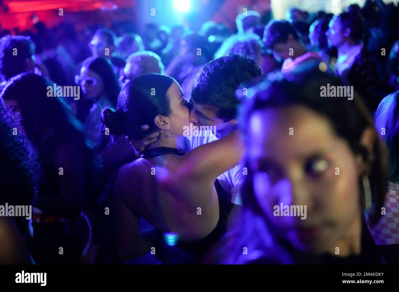 A couple kisses as they dance at a DJ party in Caracas, Venezuela ...