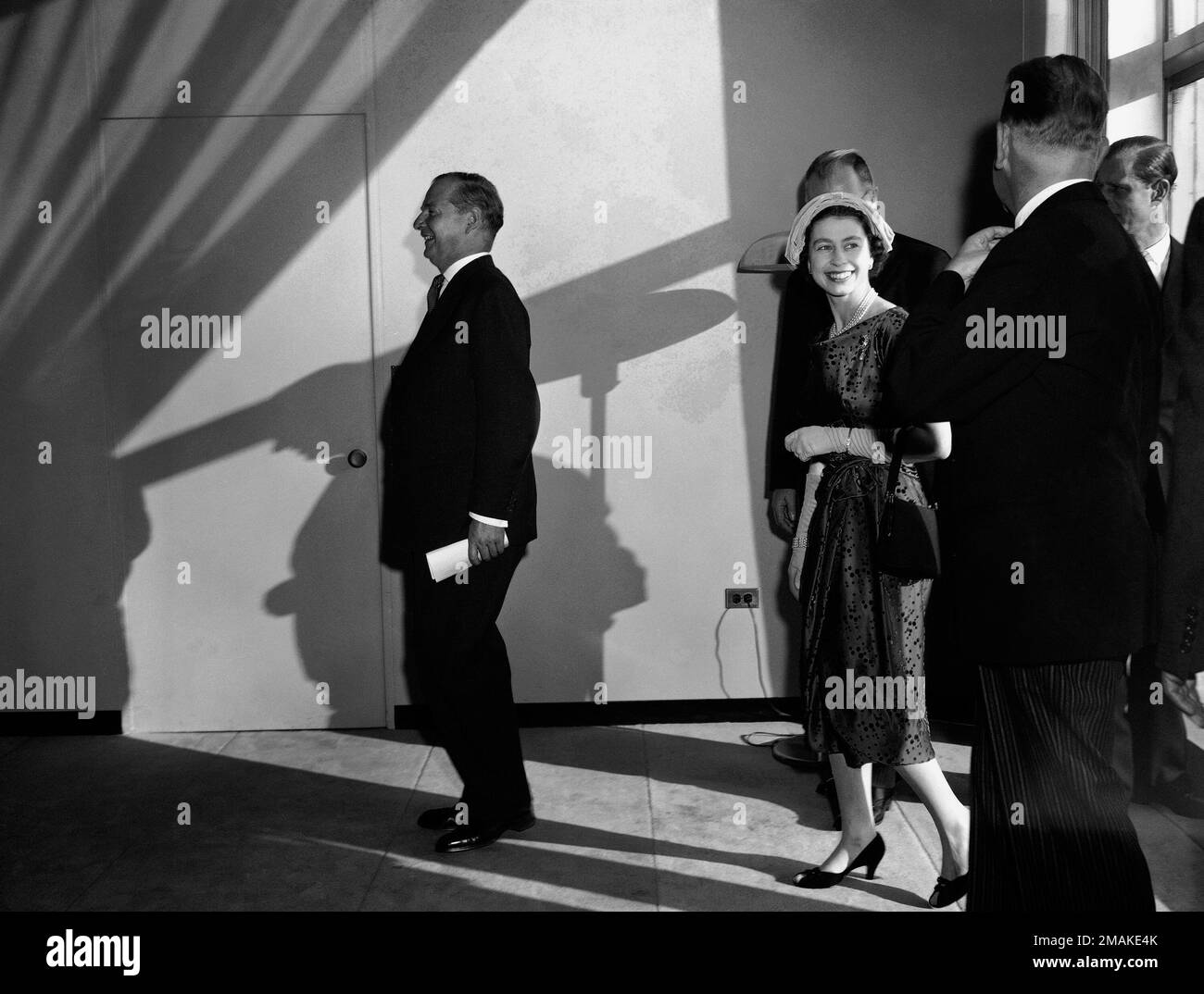 The sun casts a shadow across the face of Britain's Queen Elizabeth II ...
