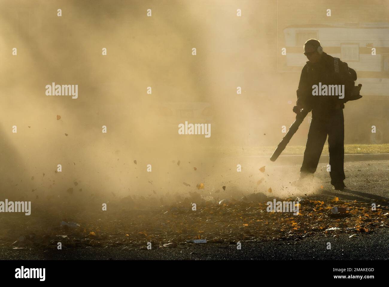 Man using backpack leaf blower in silhouette Stock Photo - Alamy