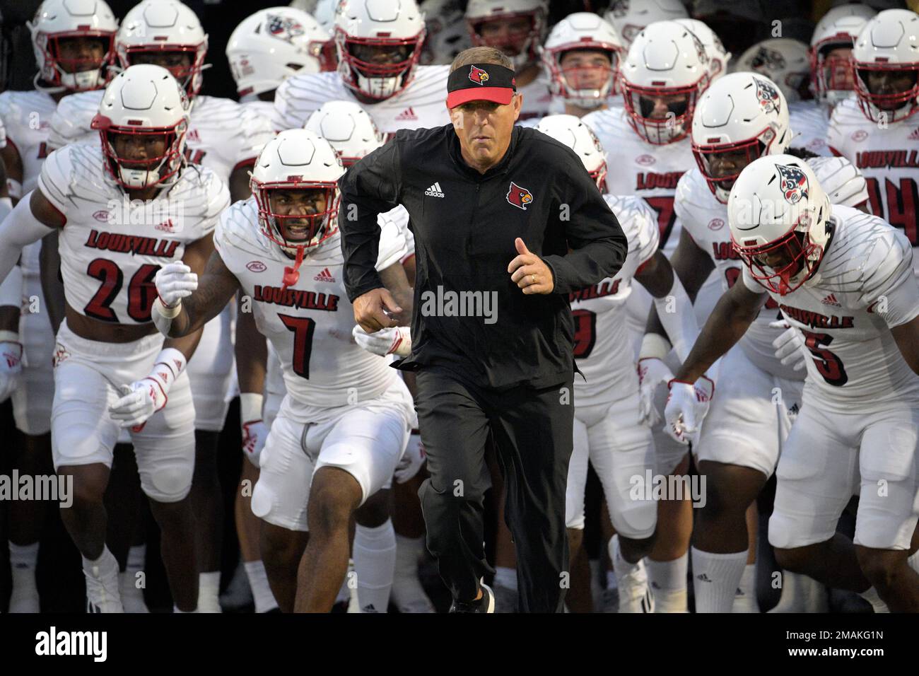 Louisville head coach Scott Satterfield, center, leads the team onto ...