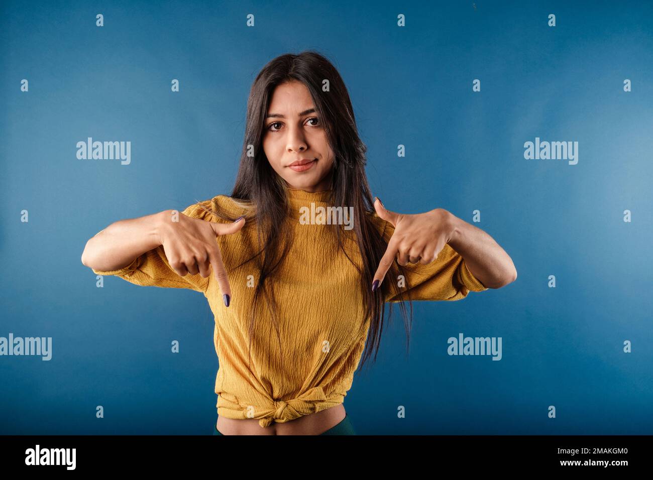 Young caucasian woman wearing casual top isolated over blue background ...