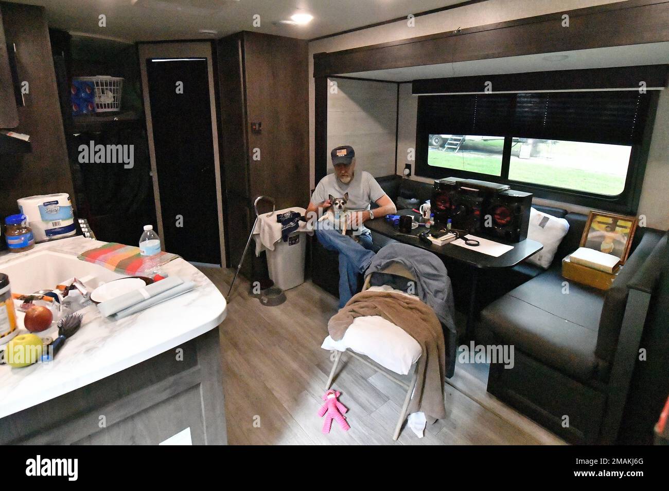 Bernard Carr, and his pet chihuahua Wiley pass the time in a travel ...