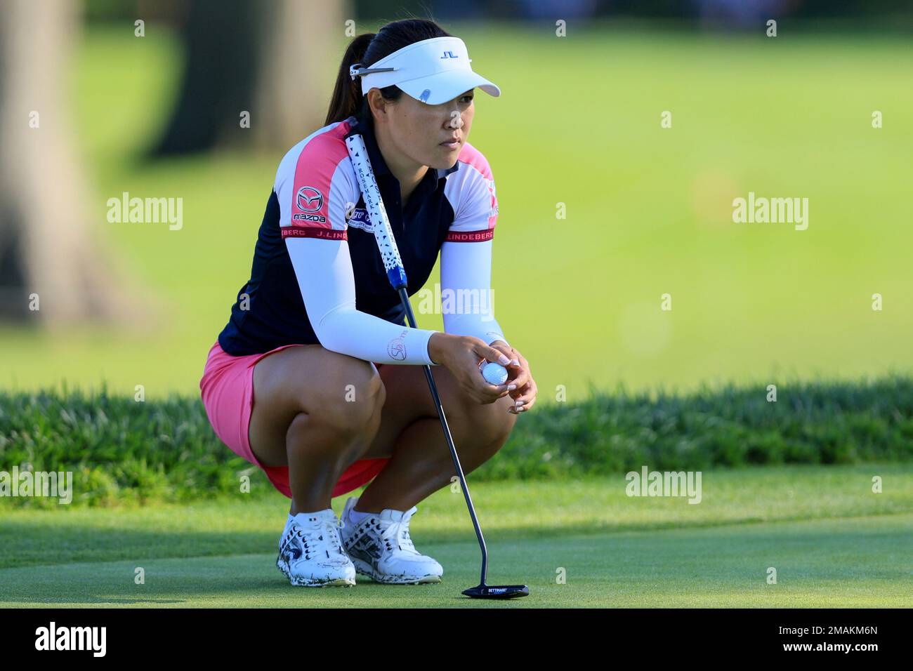Kelly Tan, of Malaysia, lines up a putt on the fifth green during the ...