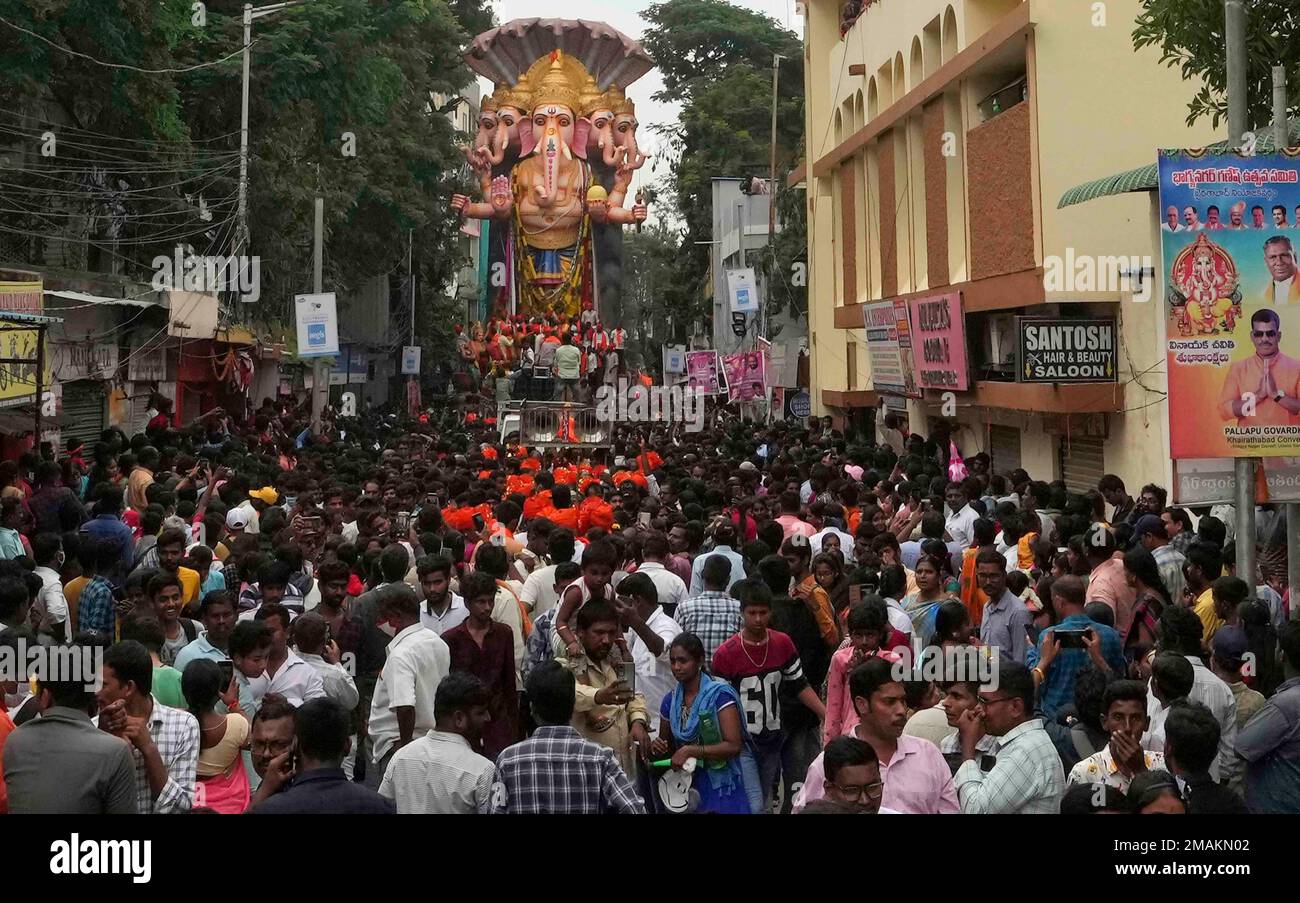 A clay idol of elephant-headed Hindu God Ganesha is taken for immersion ...
