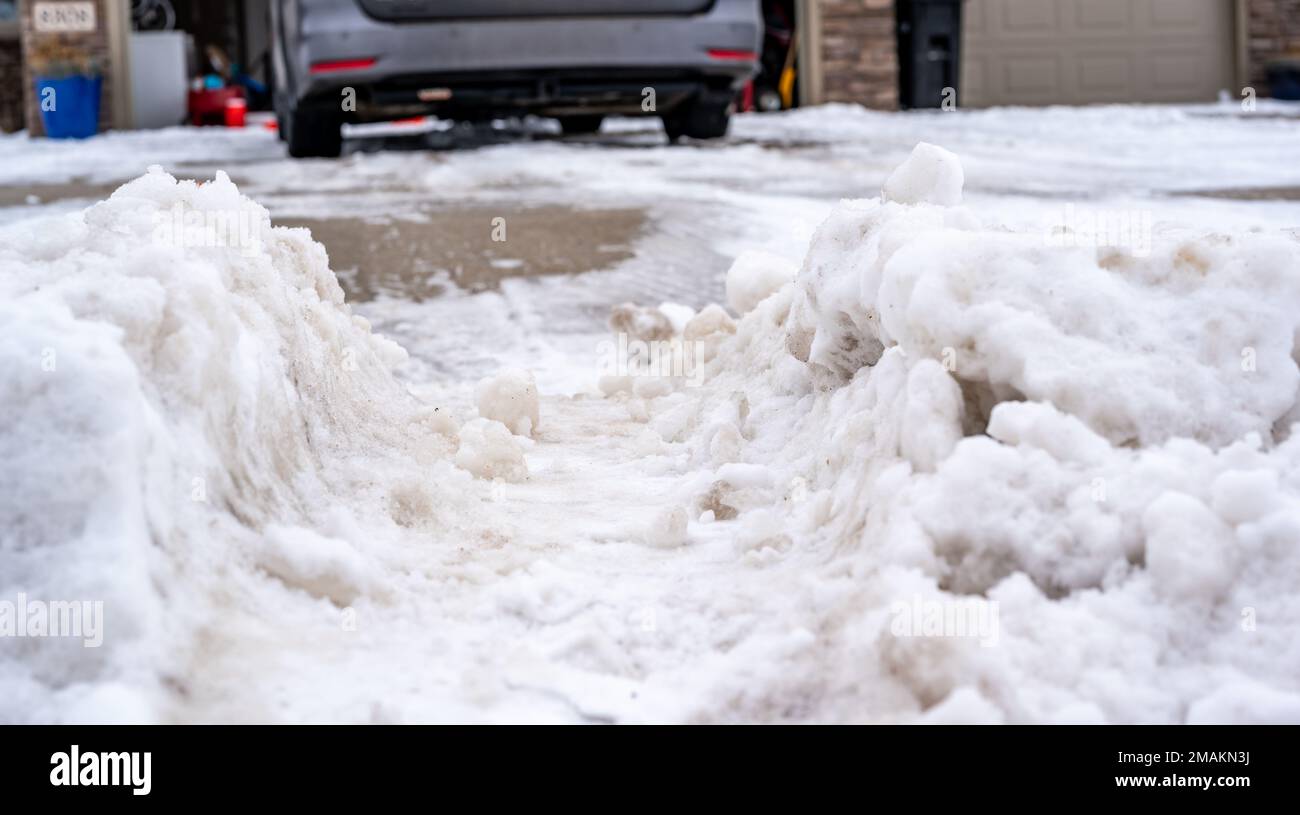 Snowbank at the end of a driveway left after city snowplows cleared a ...