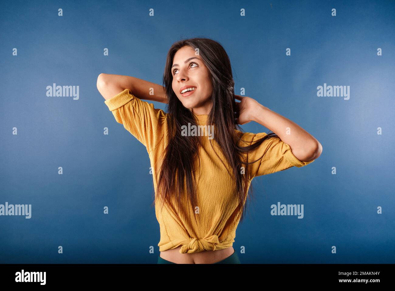 Portrait of cute dark-haired woman wearing casual top isolated over ...