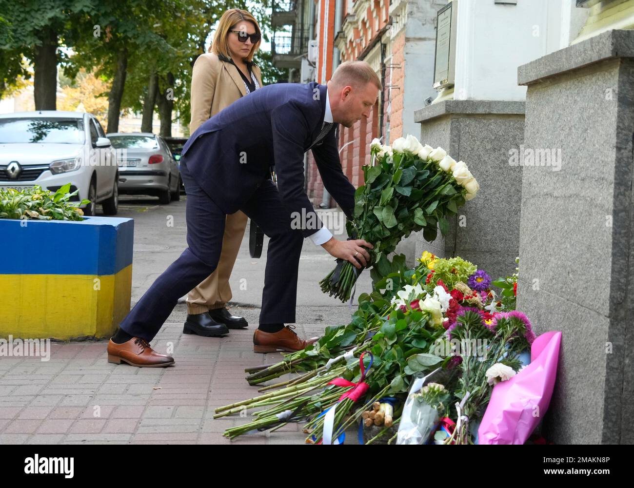 People lay flowers in remembrance of Queen Elizabeth II at the Embassy ...