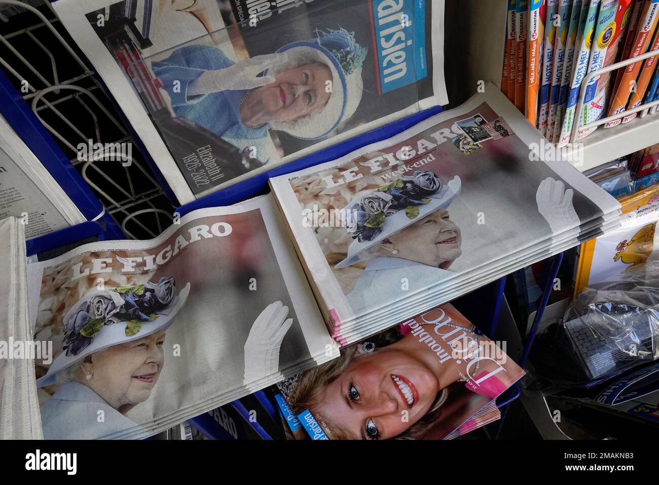Newspapers fronting pictures of Queen Elizabeth II are displayed on a ...