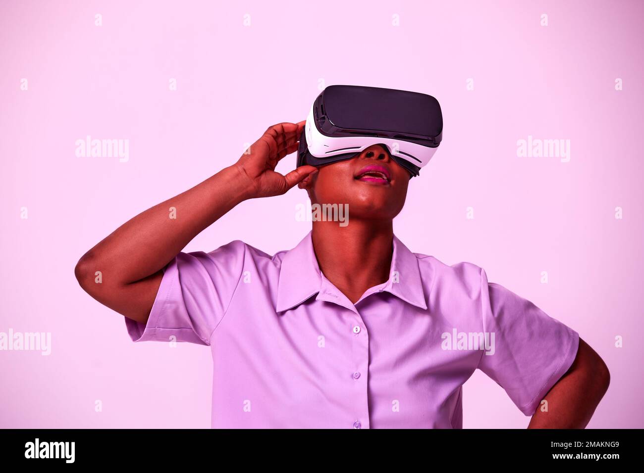 Happy young black lady in VR glasses exploring cyberspace, touching ...