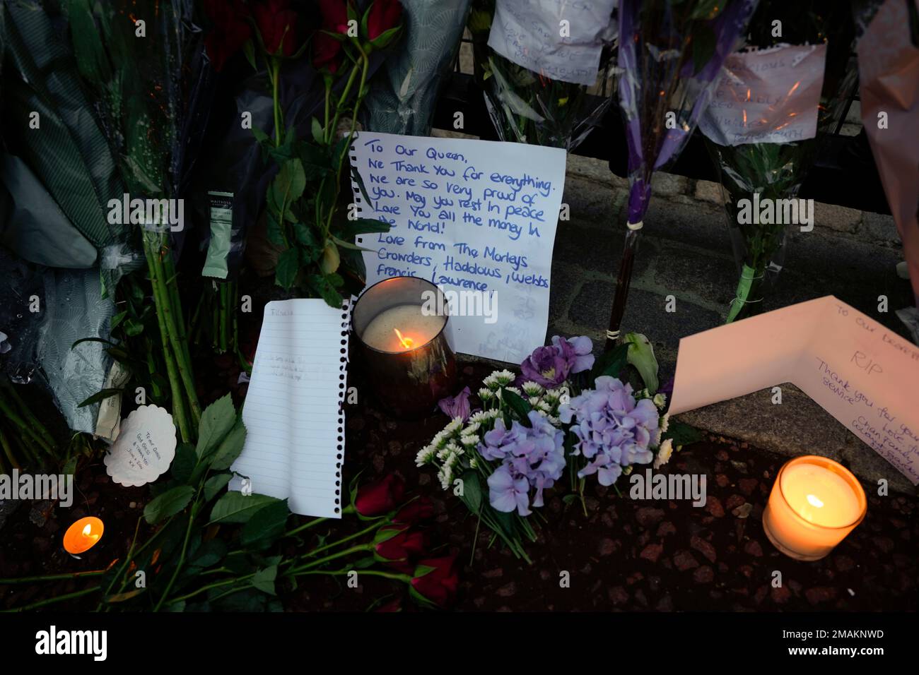 Messages, flowers and candles are seen at the gates of Buckingham ...