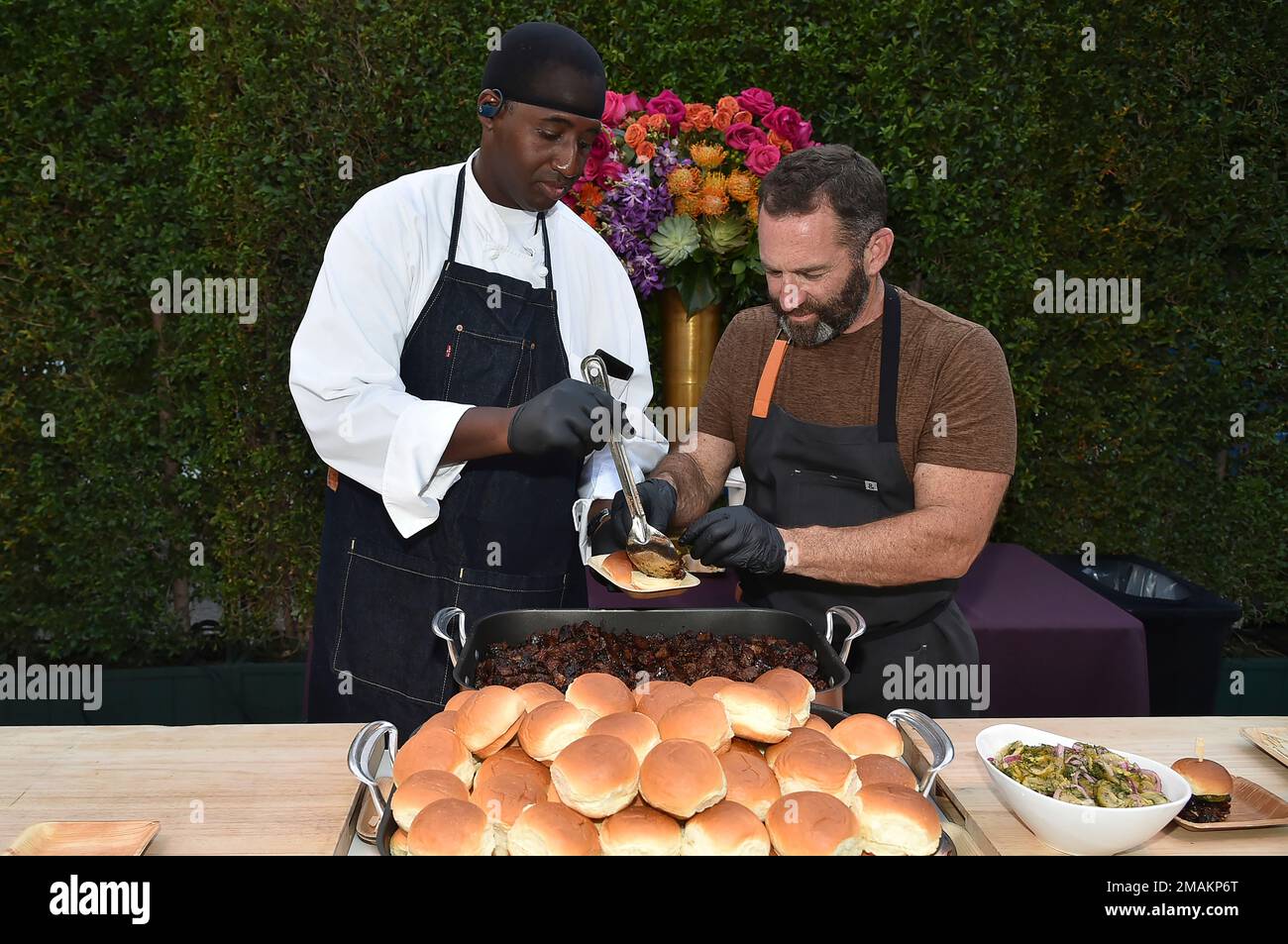 Marcus Lewis, left and Adam Perry Lang prepare a delicious pork belly ...