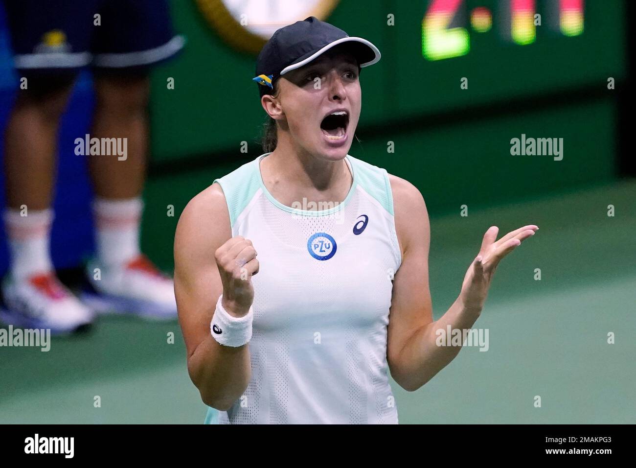 Iga Swiatek, of Poland, reacts after defeating Aryna Sabalenka, of ...