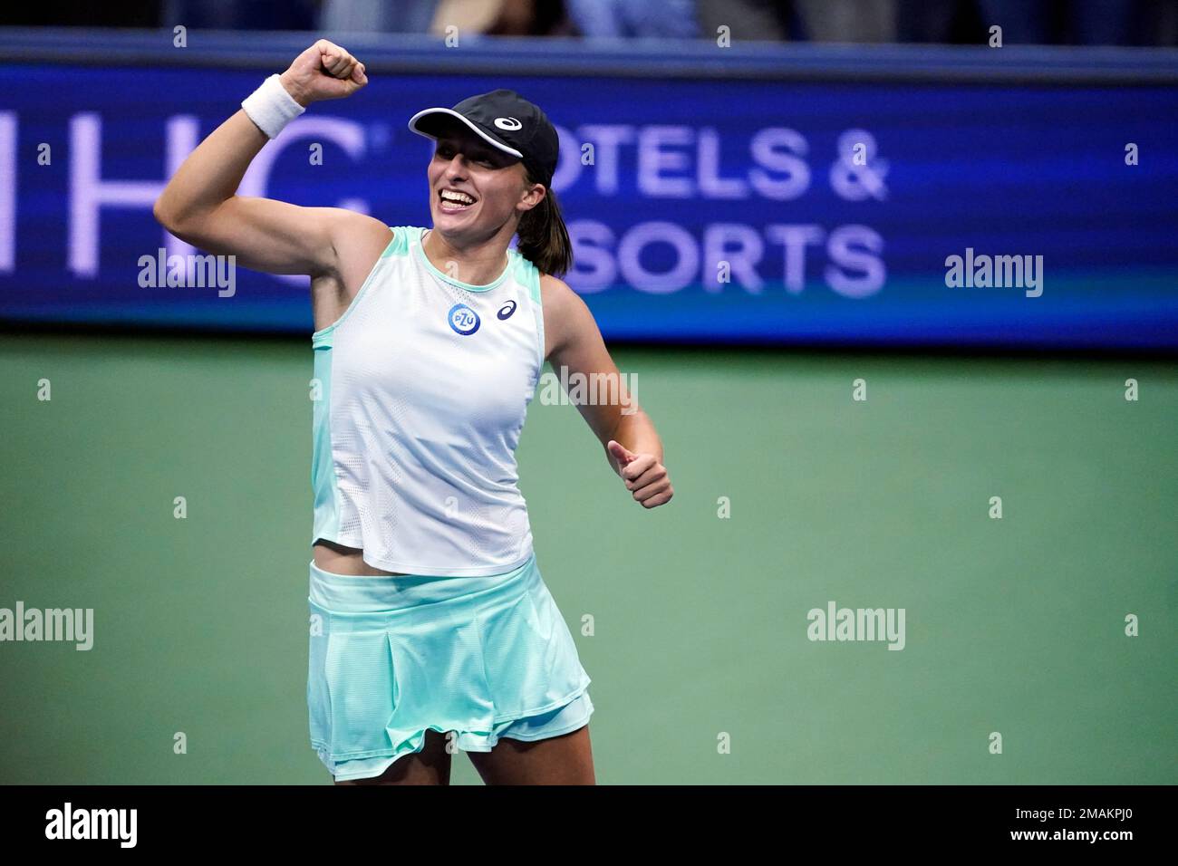 Iga Swiatek, of Poland, reacts after defeating Aryna Sabalenka, of ...