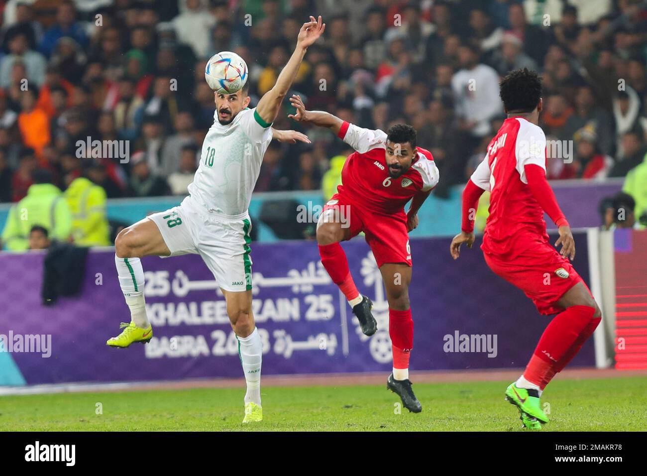 Iraq's Ayman Hussein, left, battles for the ball with Oman's Ahmed Al ...