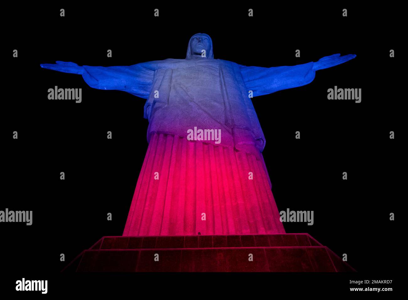 The Christ the Redeemer statue is illuminated in red, blue and white ...