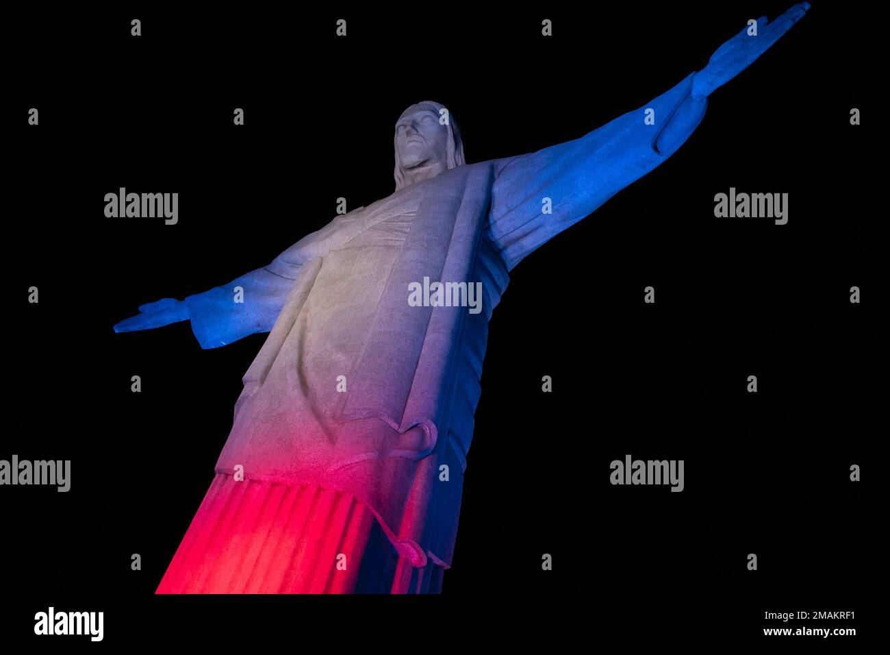 The Christ the Redeemer statue is illuminated in red, blue and white ...