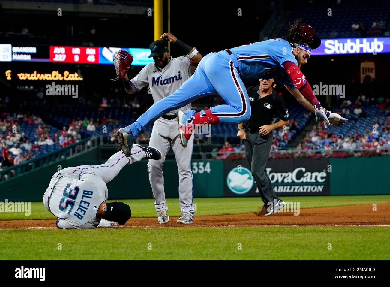 Philadelphia Phillies' Brandon Marsh, right, is tripped up after a ...