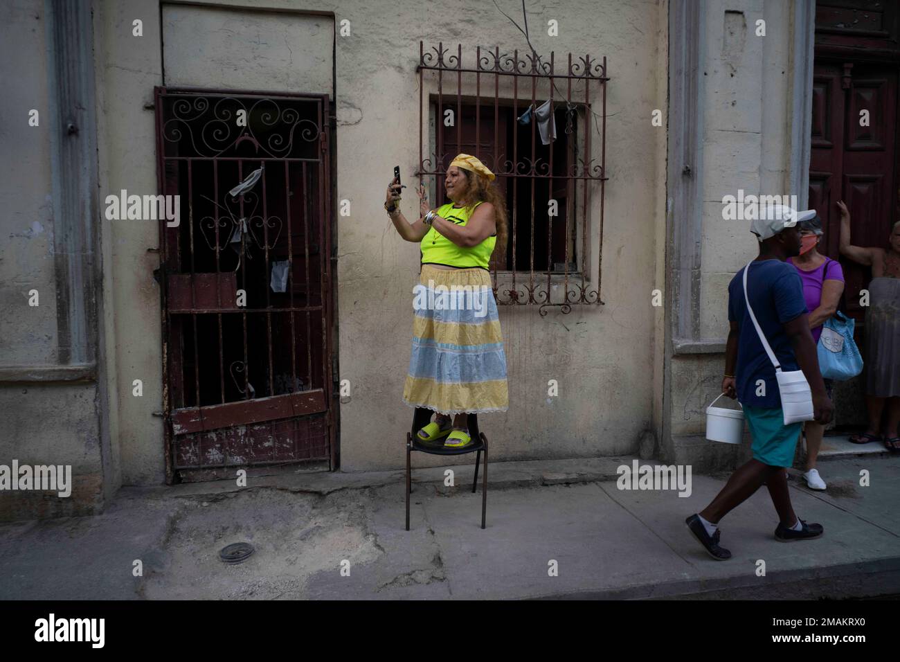 A woman watch the procession honoring the Virgen de la Caridad del ...