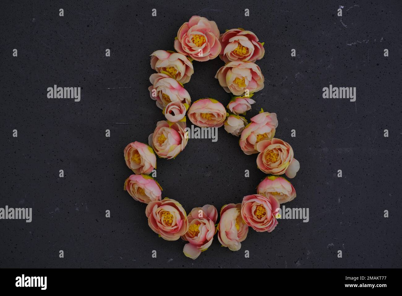 Creative layout number eight 8 made with flowers on dark grey ...