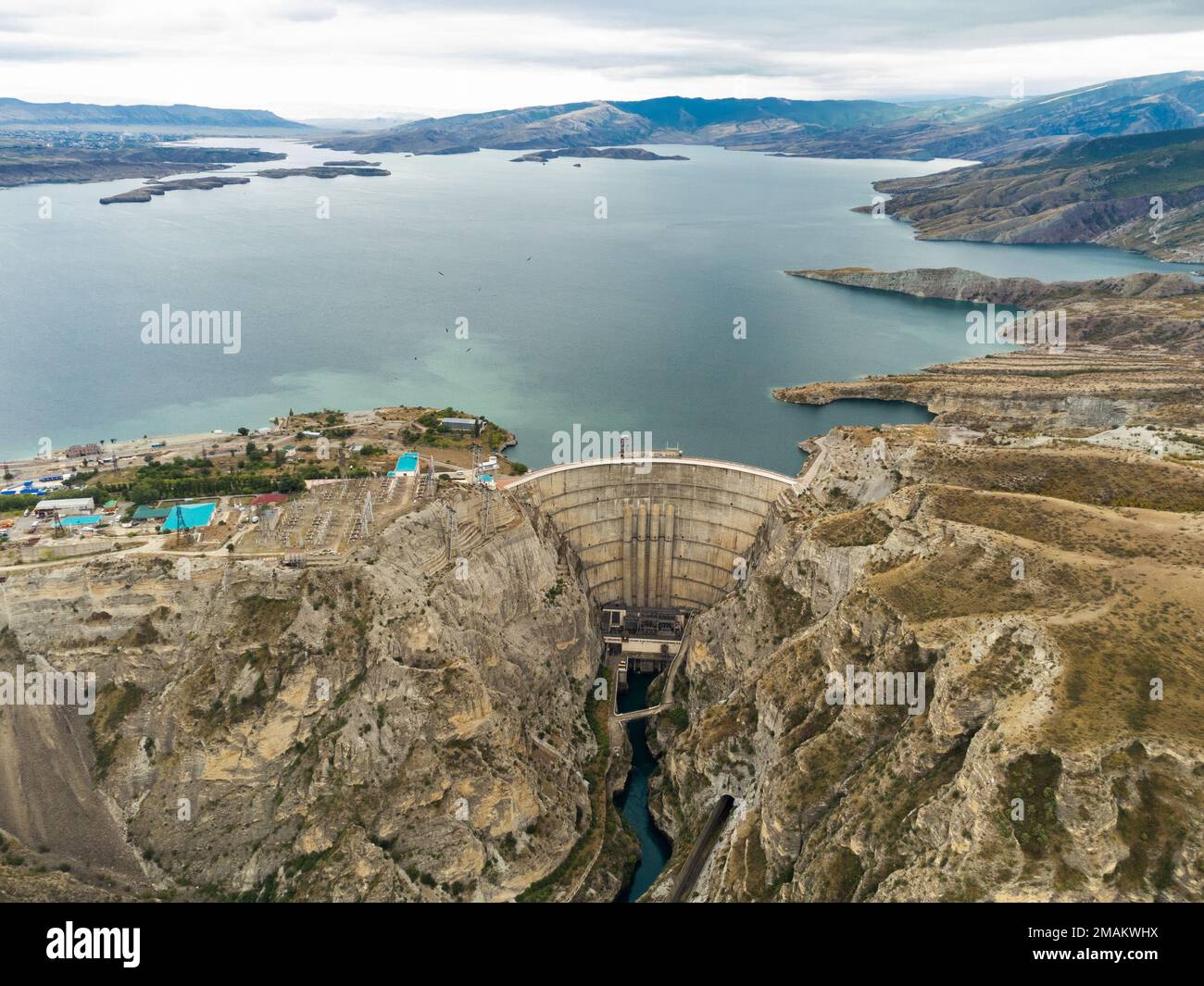 view of the lower part of the arch dam with a spillway in the canyon ...
