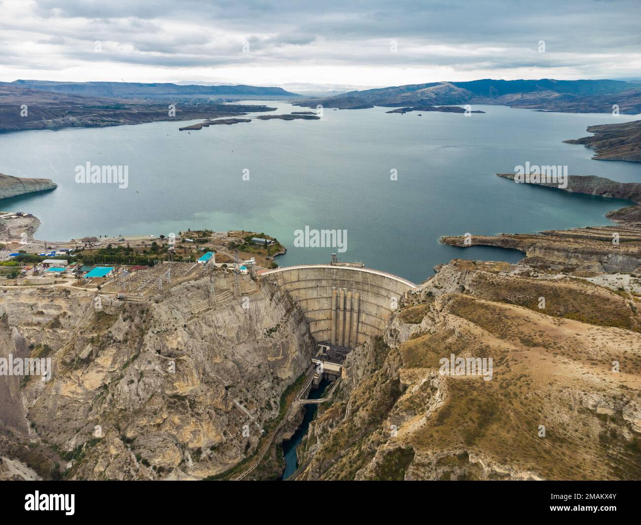 view of the lower part of the arch dam with a spillway in the canyon ...