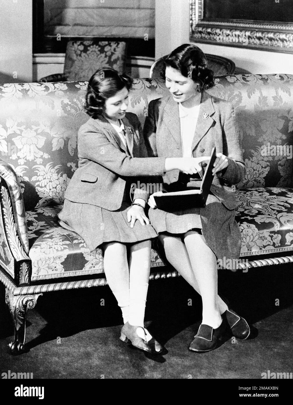 FILE - Britain's Princess Margaret Rose, left, points to an interesting ...