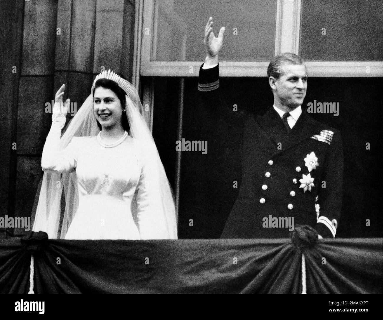 FILE - Britain's Princess Elizabeth and Prince Philip, the Duke of Edinburgh wave to the crowds ...