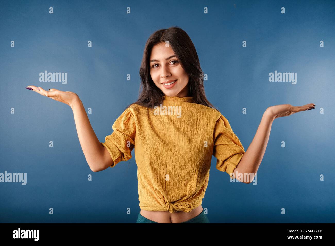 Portrait of cute dark-haired woman wearing casual top isolated over ...