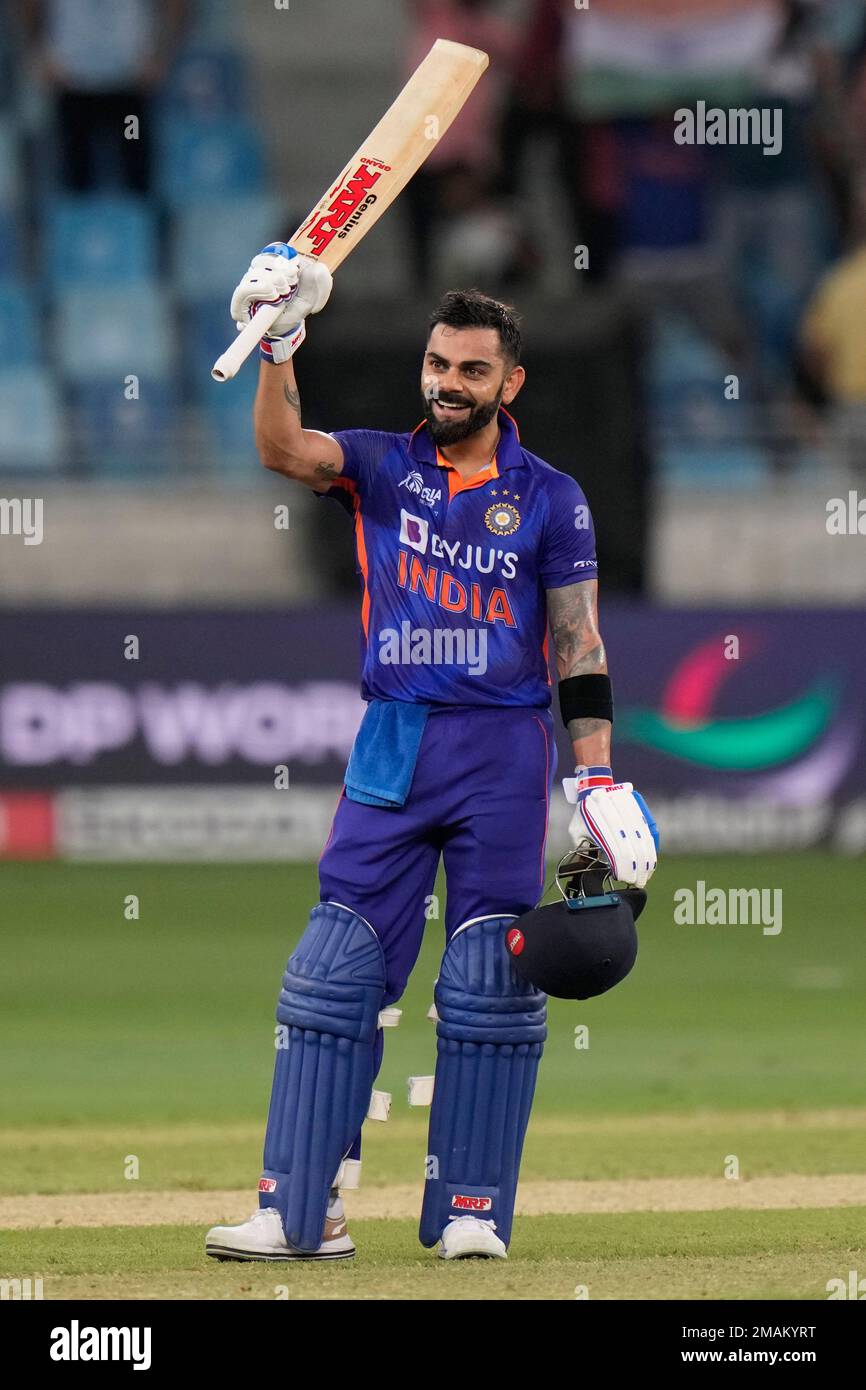 India's Virat Kohli raises his bat to celebrate scoring a century ...