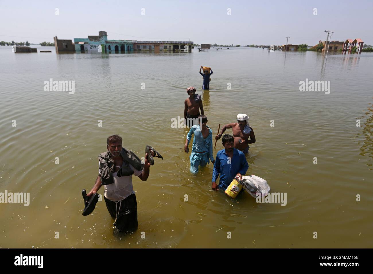 Victims of flooding from monsoon rains carry belongings salvaged from ...