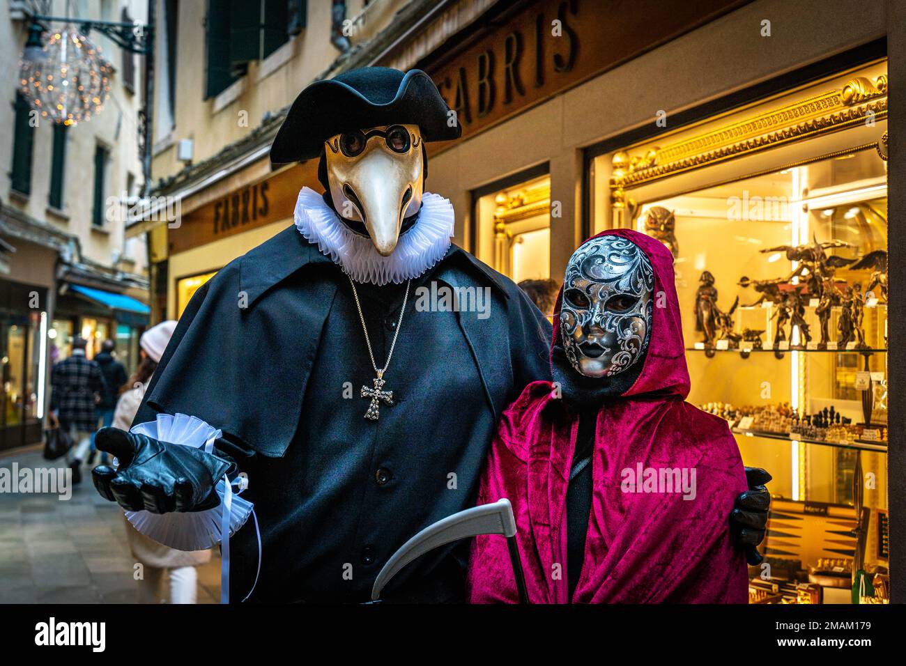 A man in a plague doctor costume and a woman in a death costume stand ...