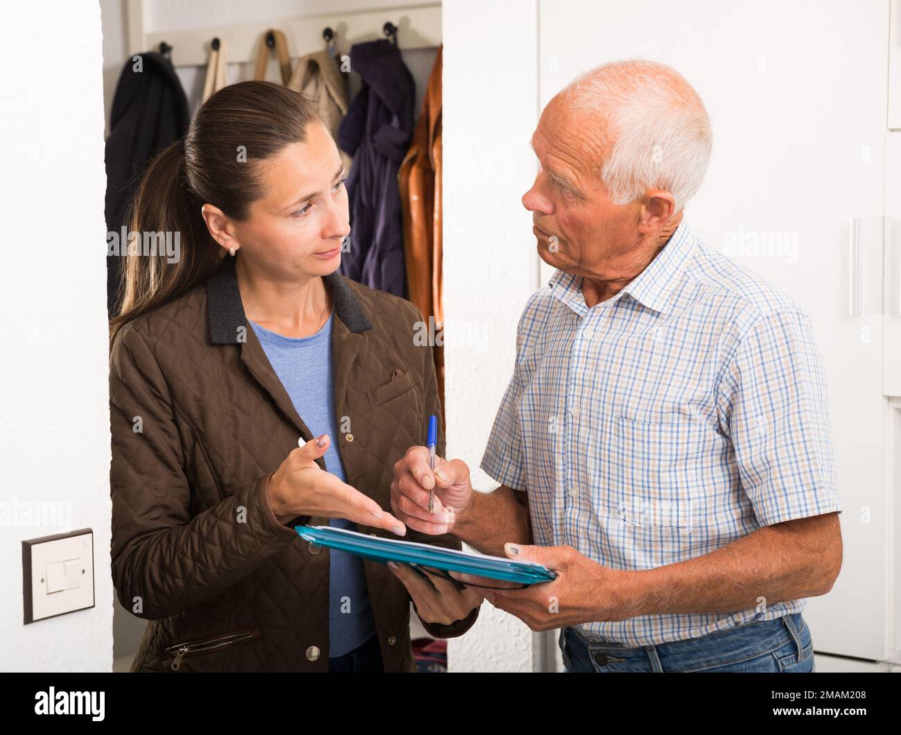 Elderly man signing financial agreement with bank worker Stock Photo ...
