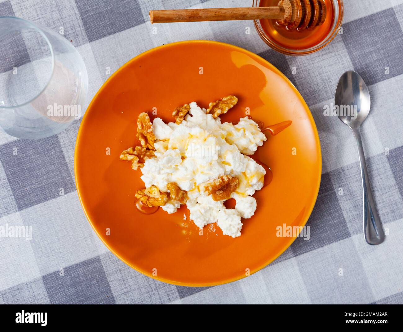 Fresh cottage cheese with honey and walnuts Stock Photo - Alamy