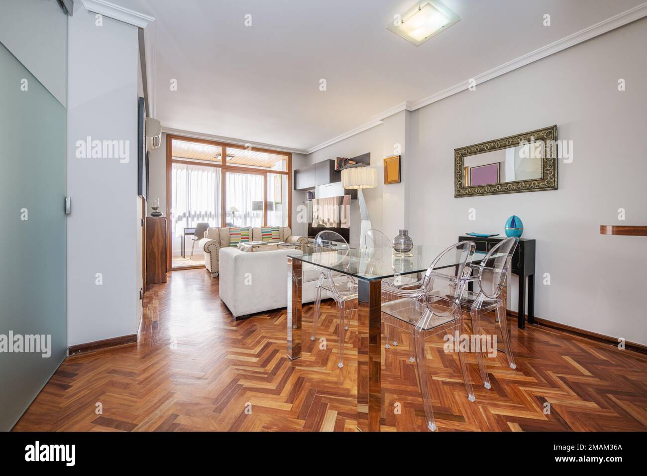 Loft-style apartment with a living room furnished with white sofas and ...