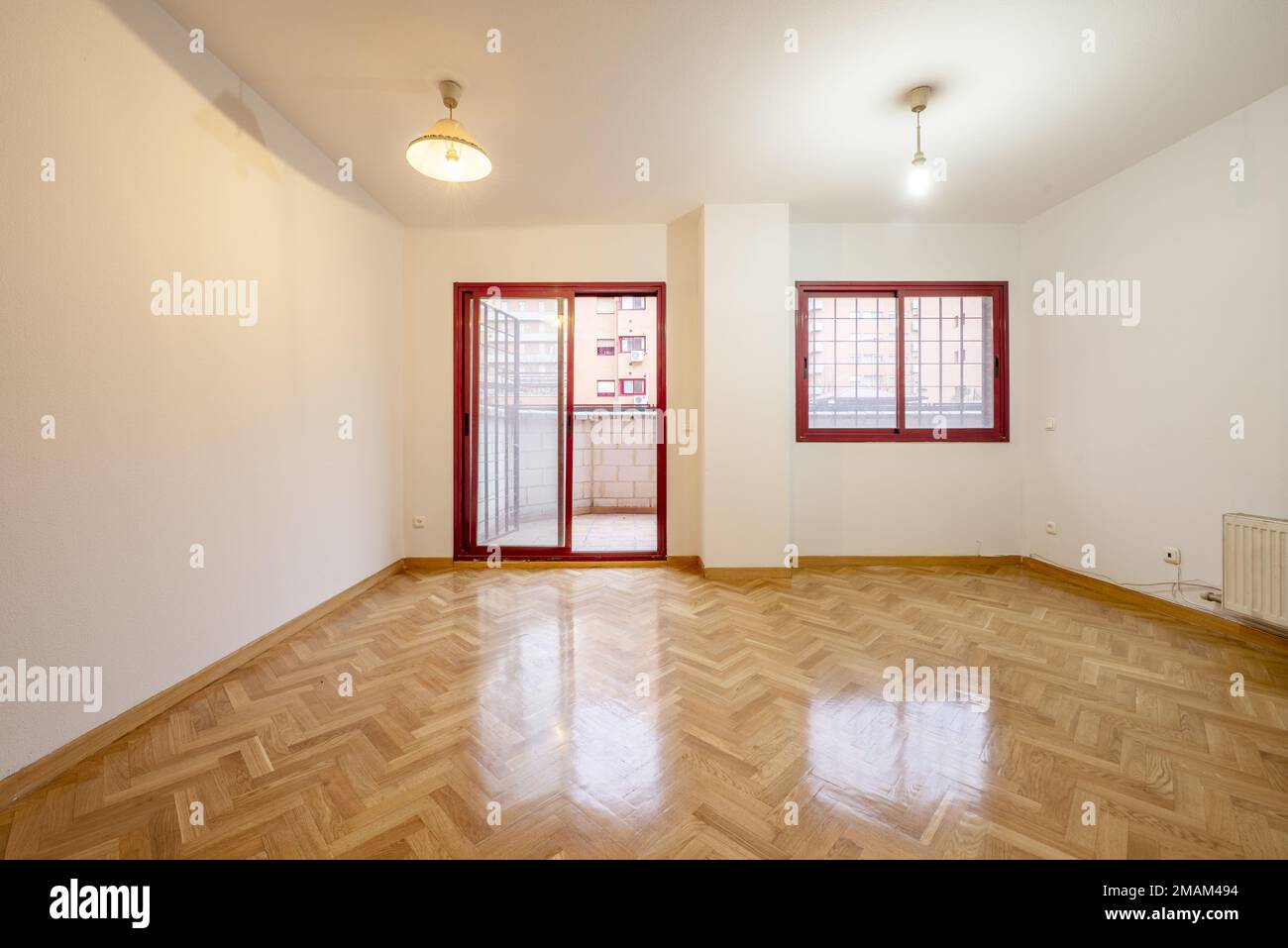 Living room of an empty house with red anodized aluminum windows with ...