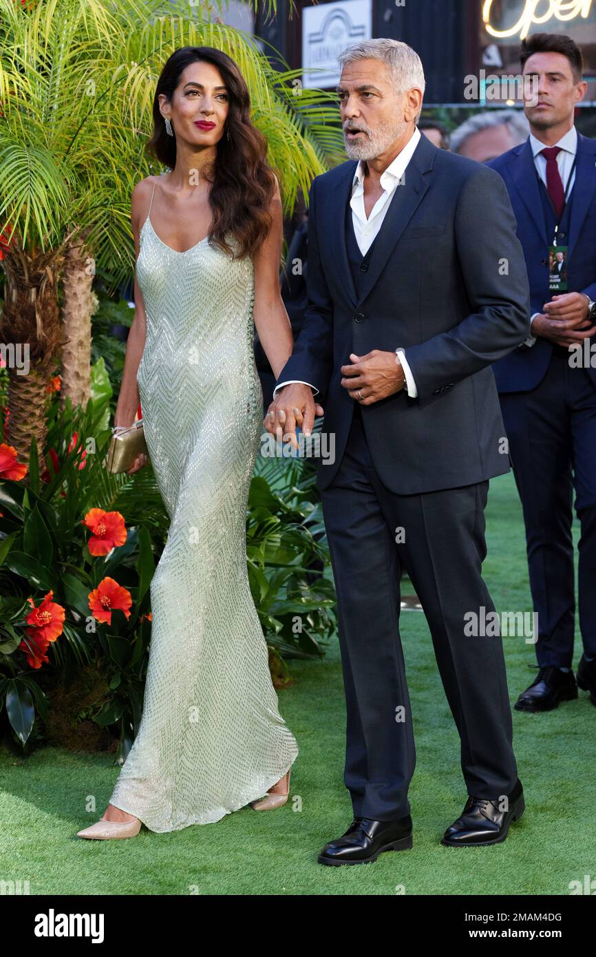 Amal Clooney, left, and George Clooney pose for photographers upon ...