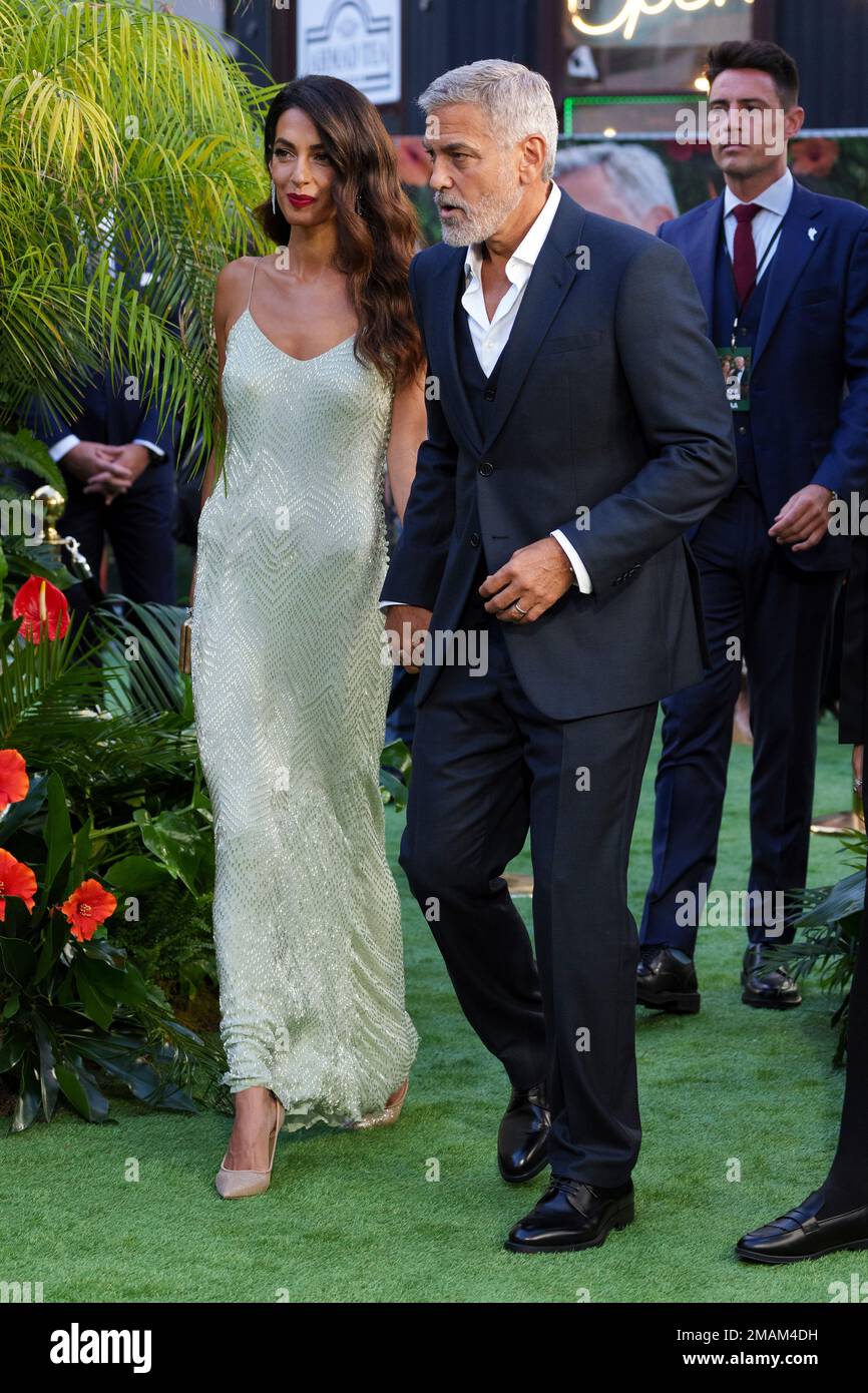 Amal Clooney, left, and George Clooney pose for photographers upon ...