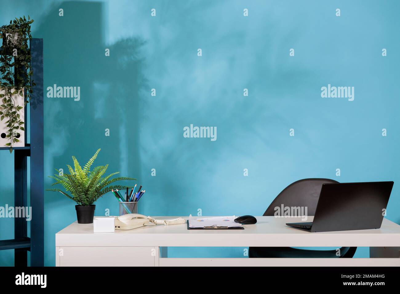 Empty workstation with notebook and optical mouse on table with indoor ...