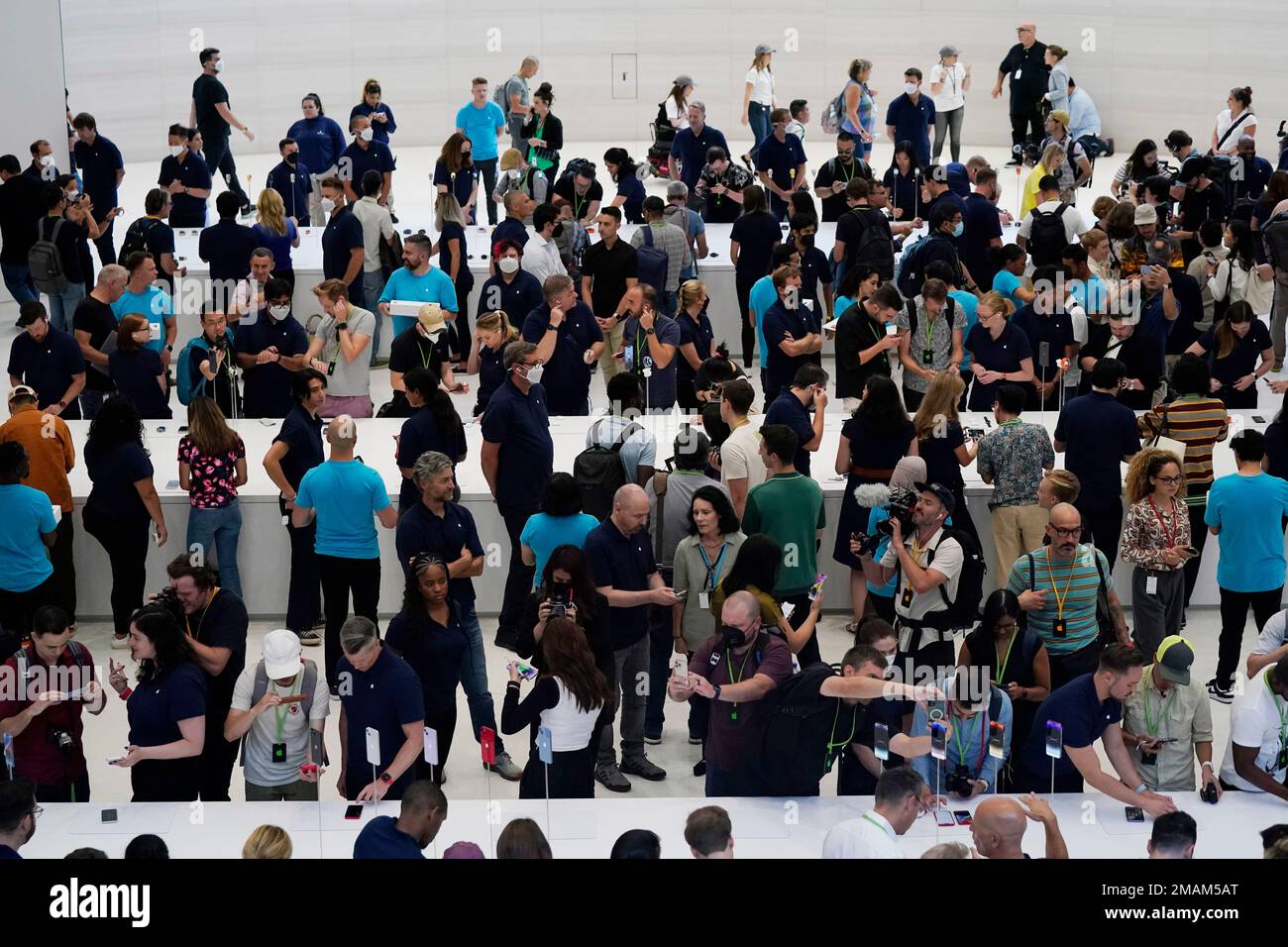 People look at new products on display at an Apple event on the campus ...