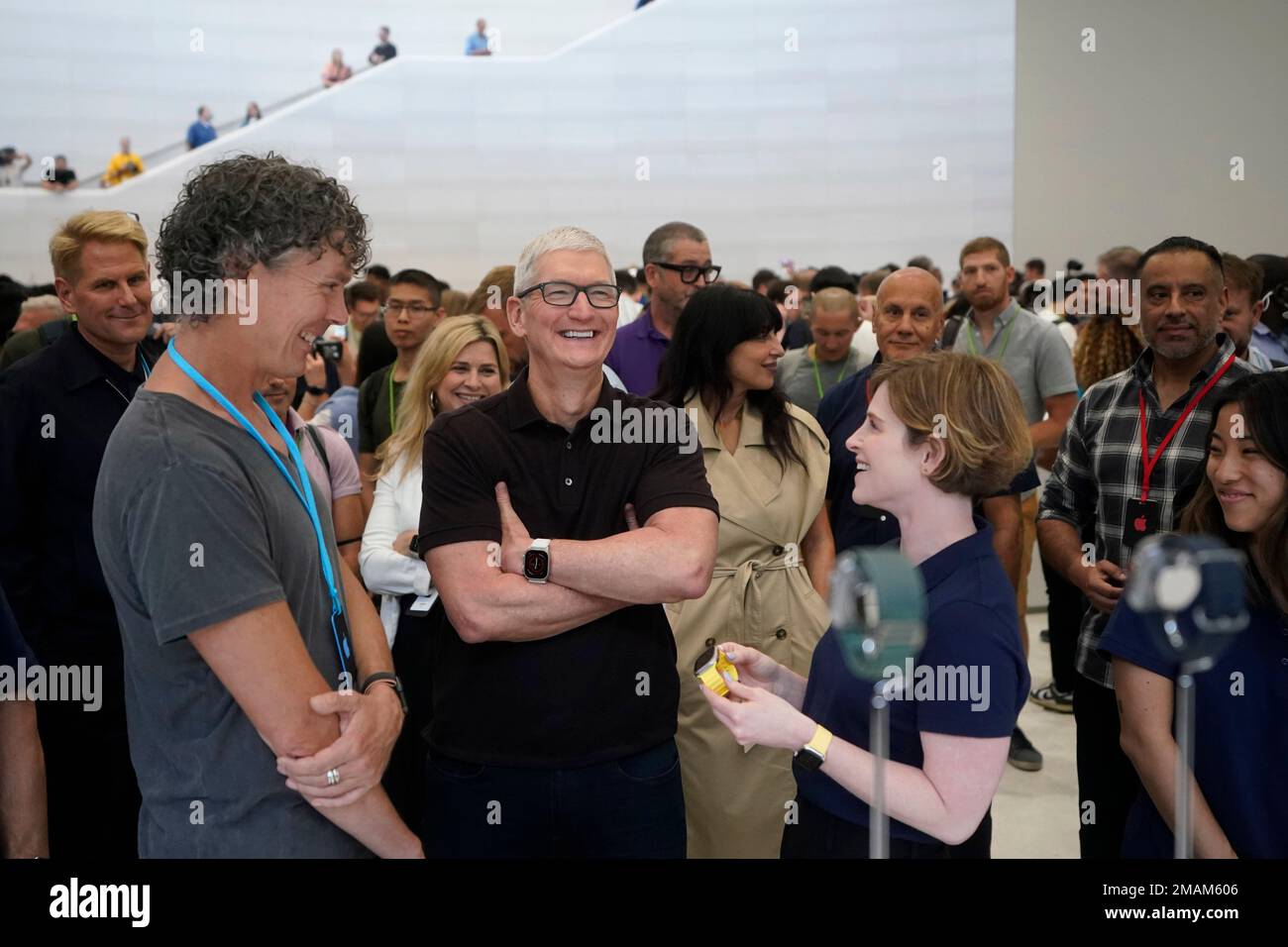 Apple CEO Tim Cook, center, looks at new Apple Watch models at an Apple ...